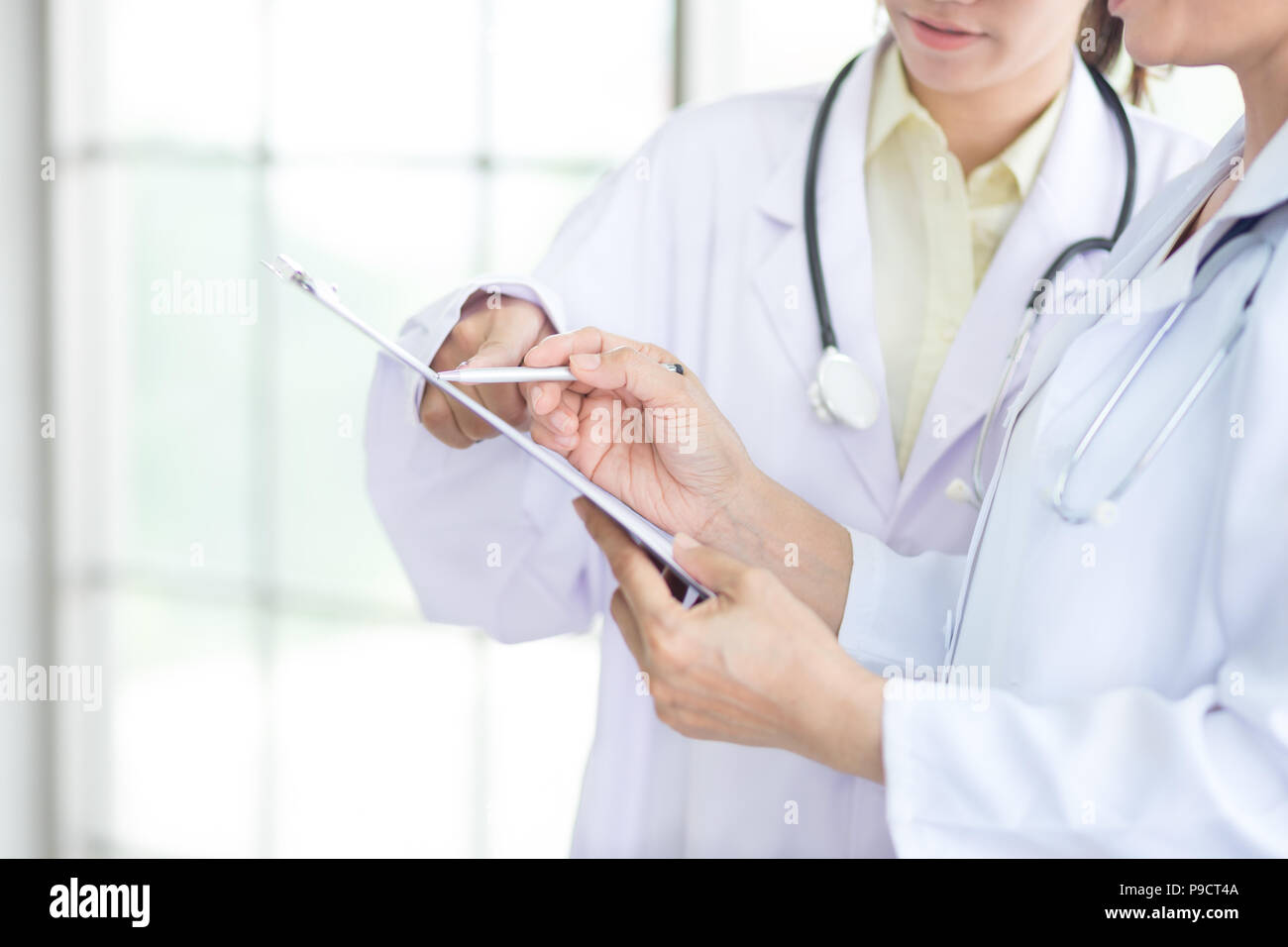 two doctor with stethoscope discuss together with patient case study ...