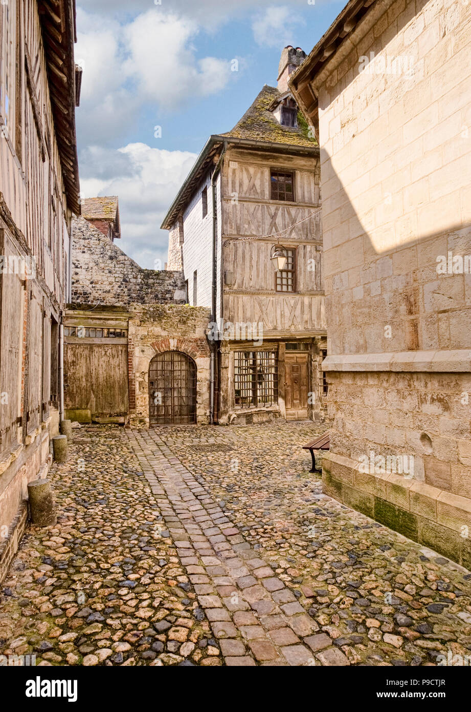 Old medieval cobbled street with wooden buildings in Honfleur, Normandy ...