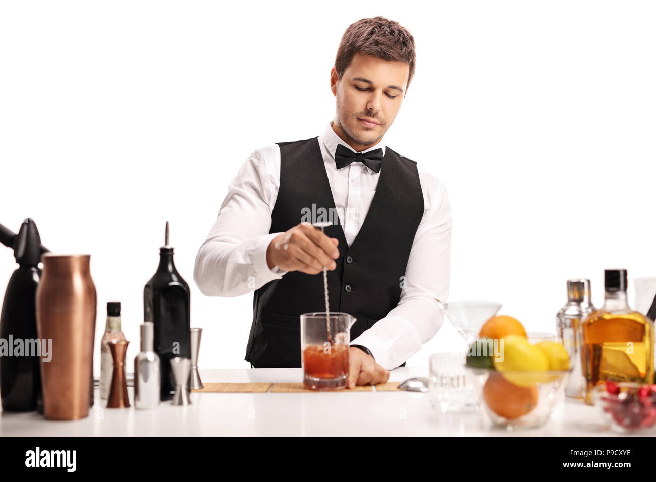 Bartender making a cocktail isolated on white background Stock Photo ...