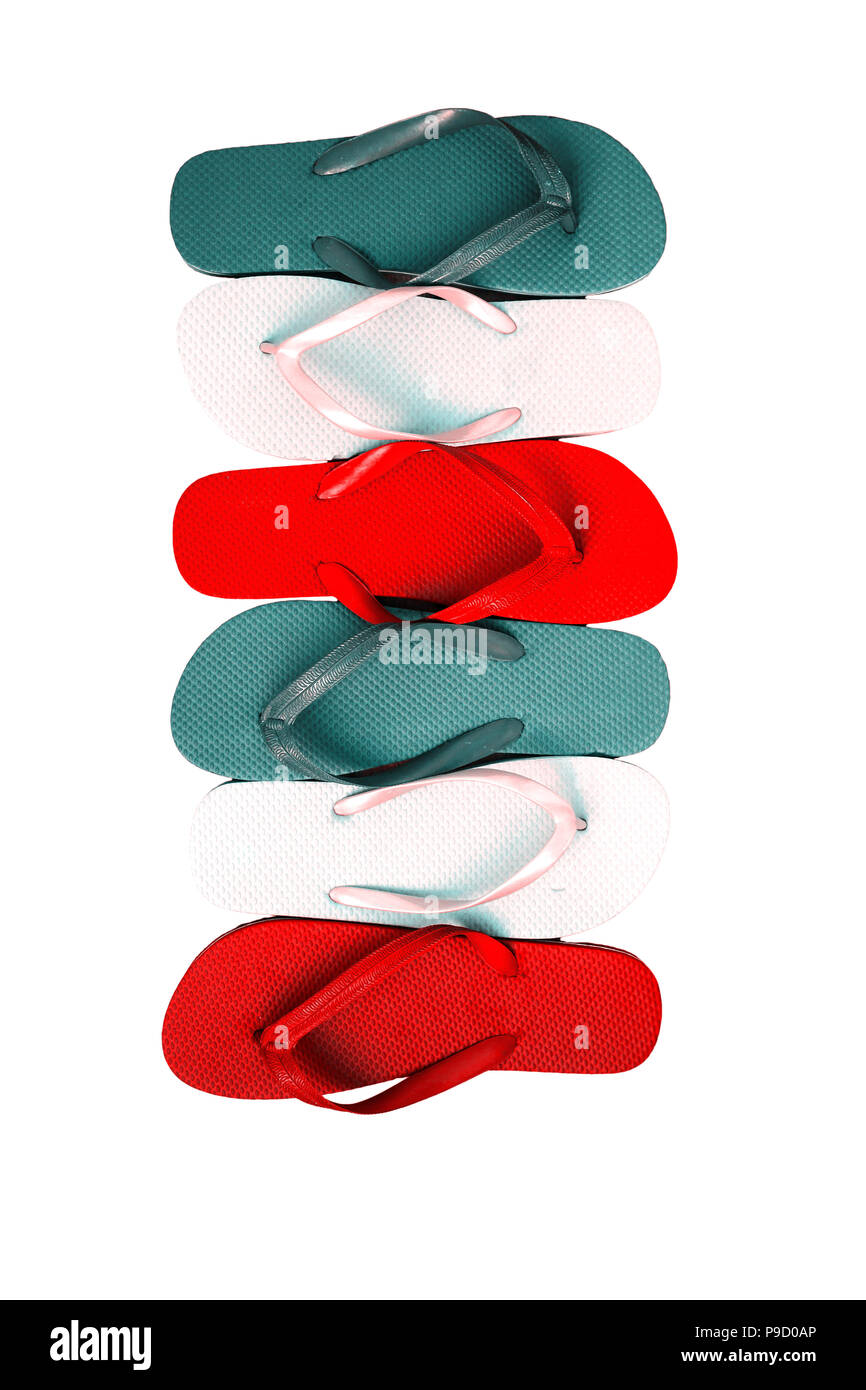Several pairs of multi-colored rubber flip-flops exhibited in a row ...