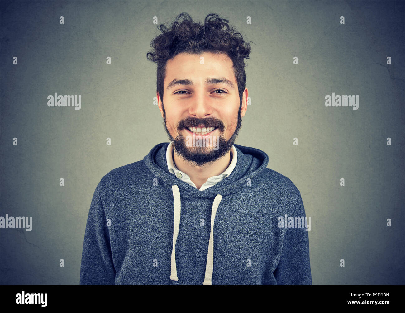 Closeup of happy bearded handsome man blue hoodie smiling cheerfully at ...