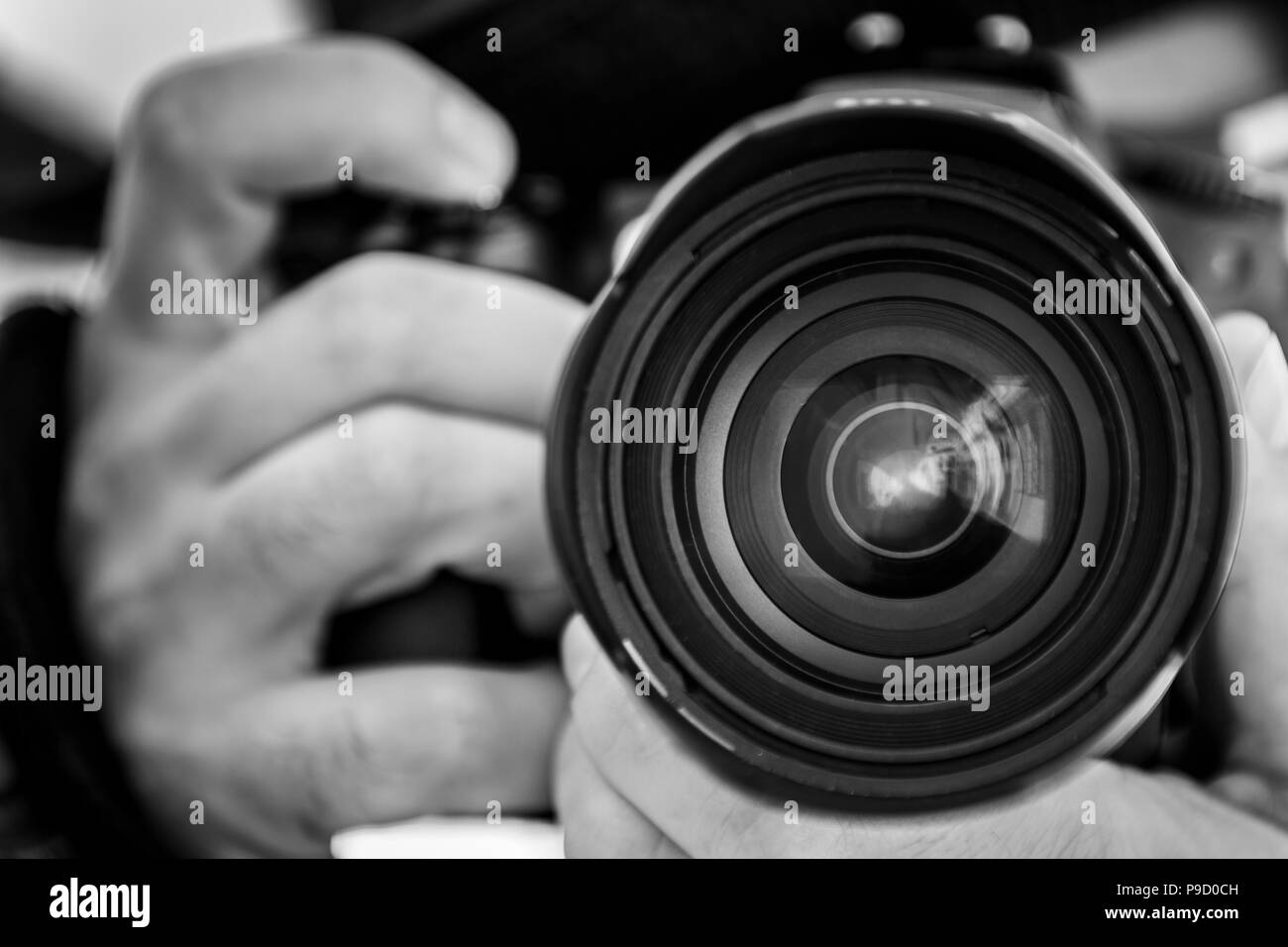 Close-up black and white shot of crop hands holding professional photo ...