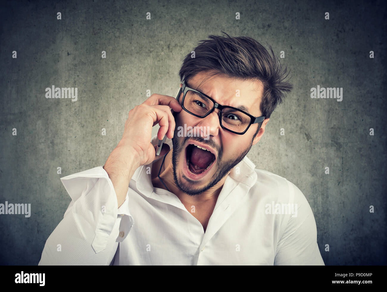 Rude furious man in glasses and white shirt having phone call and ...
