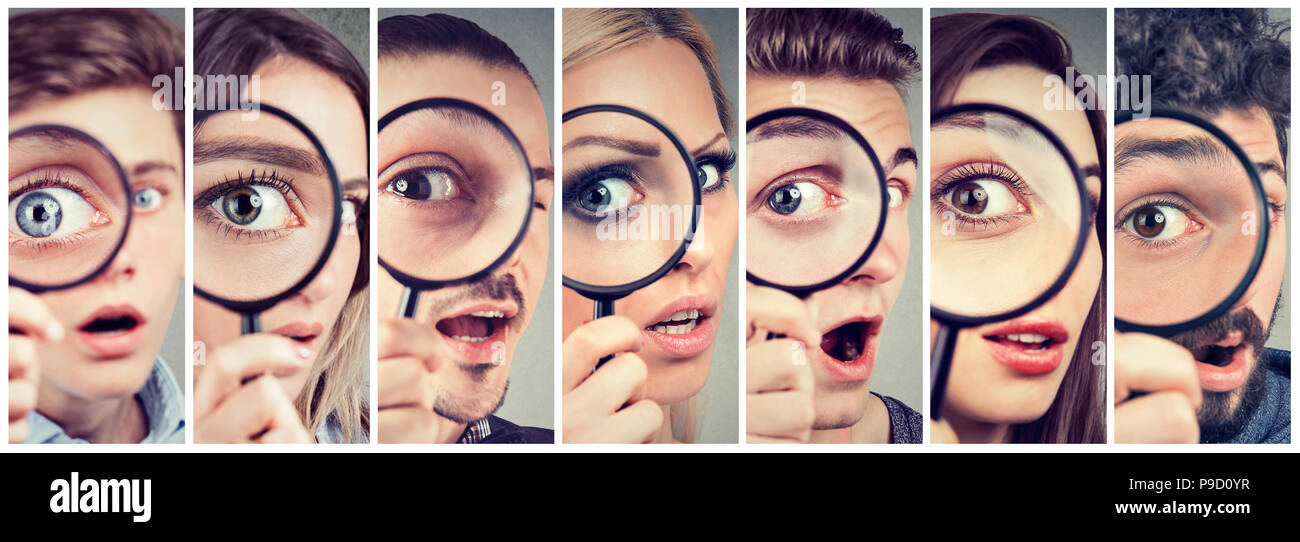 Group of curious young women and men looking through a magnifying glass ...