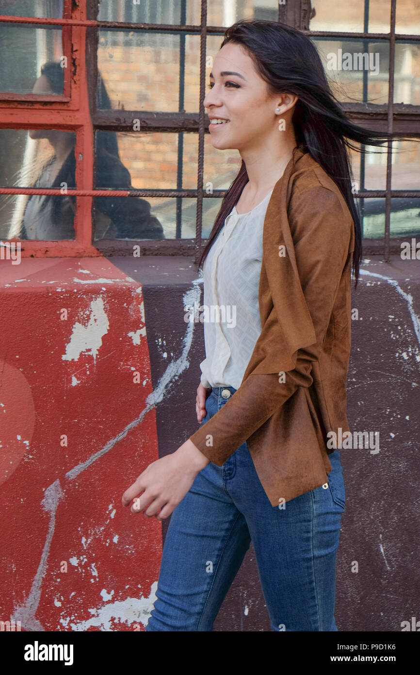 Female walking along a sidewalk on an urban street Stock Photo - Alamy