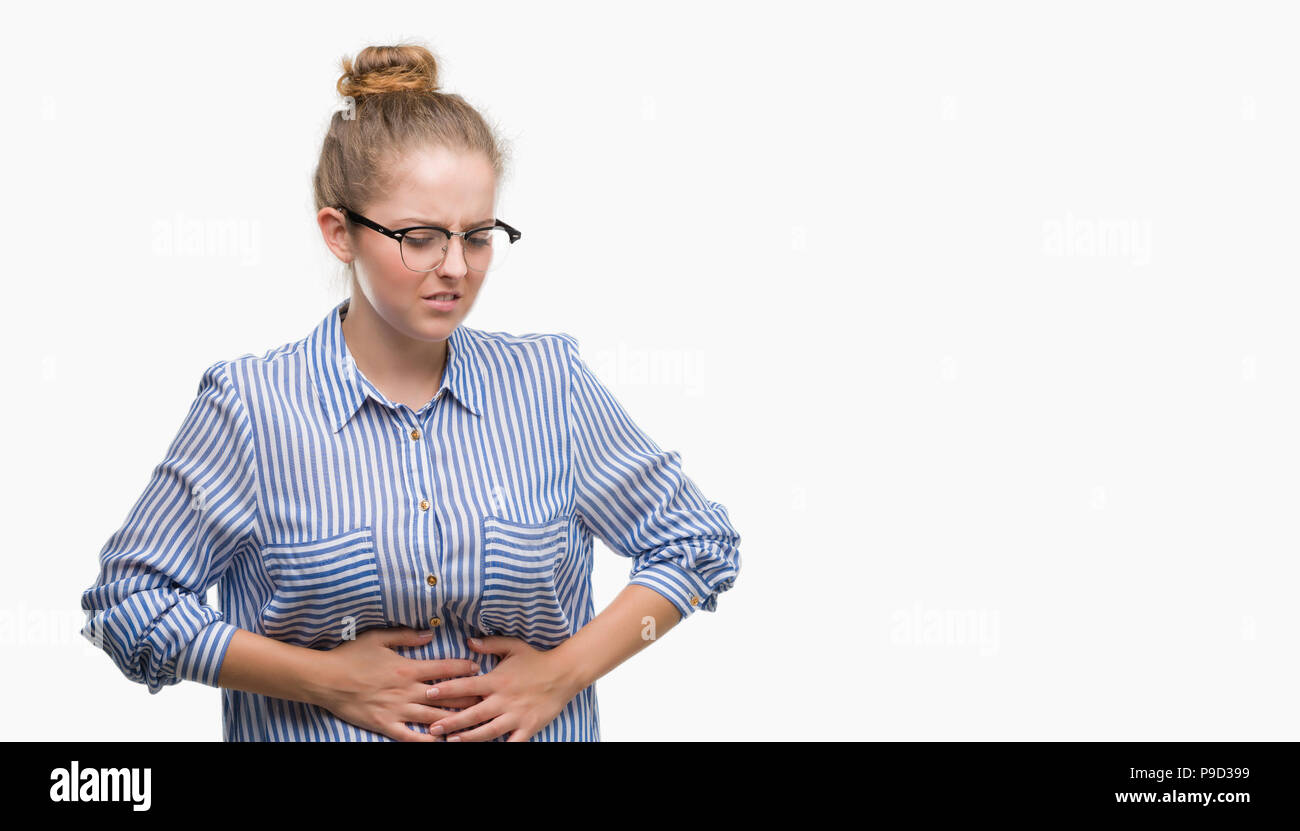 Young blonde business woman with hand on stomach because indigestion ...
