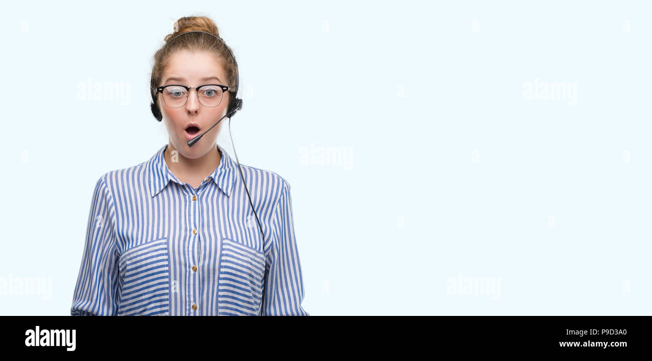 Young blonde call center operator woman scared in shock with a surprise ...