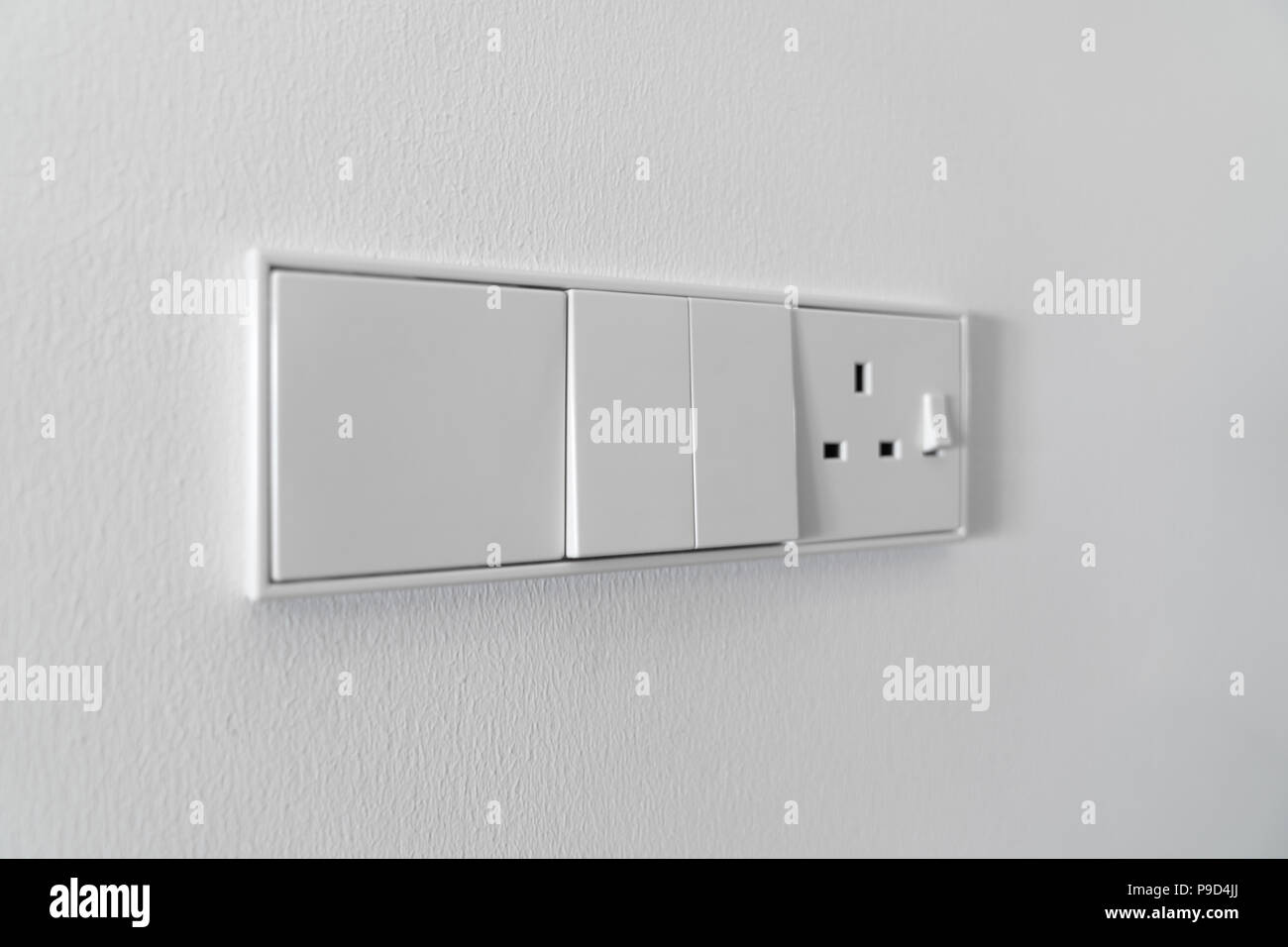 Modern white switch on white wall background Stock Photo - Alamy