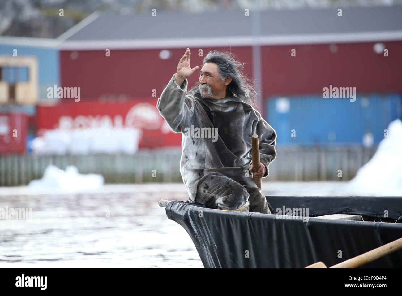 Greenland, Nanortalik, inuit male in traditional dress holding paddle ...