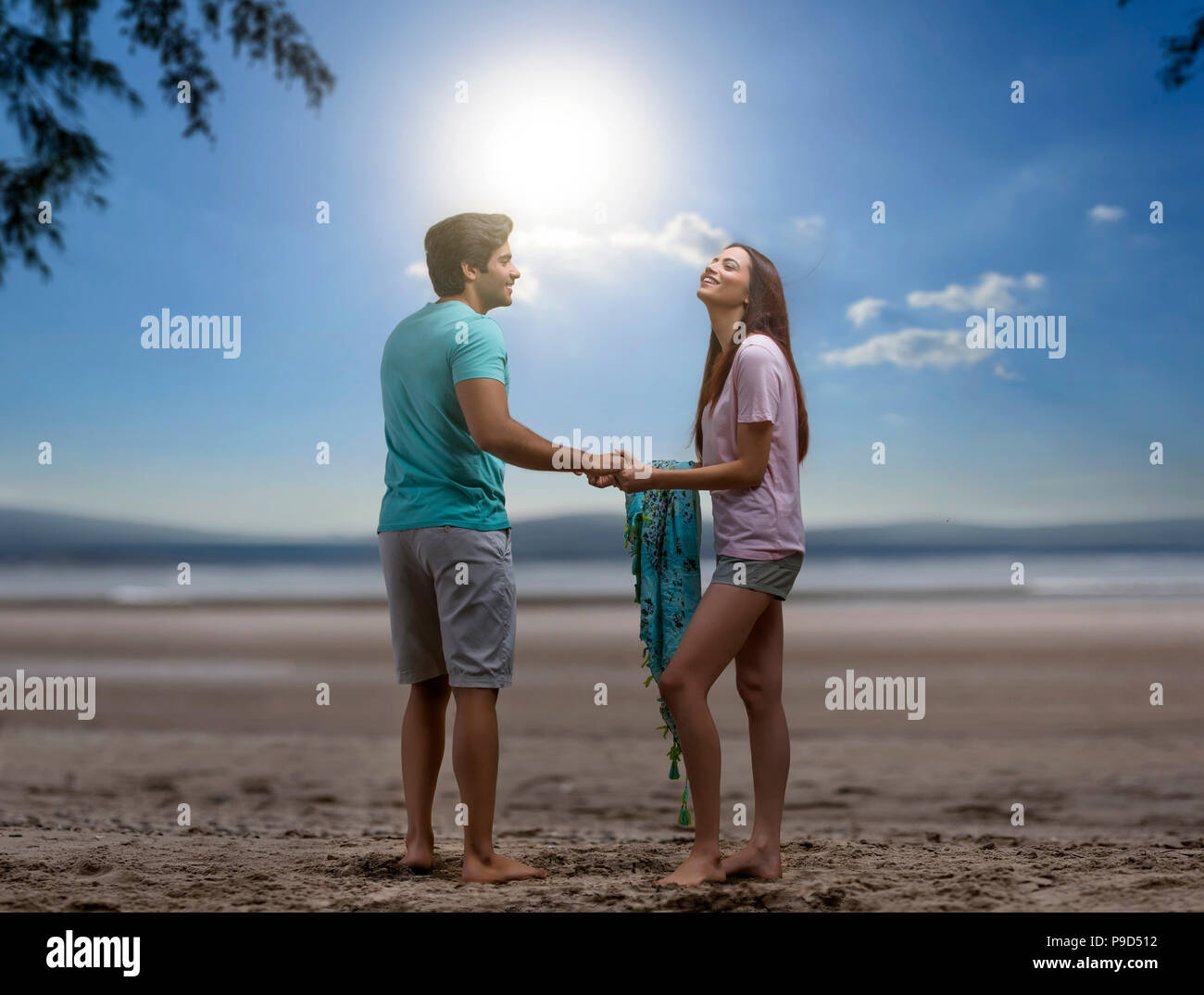 Happy couple hand in hand on the beach Stock Photo - Alamy