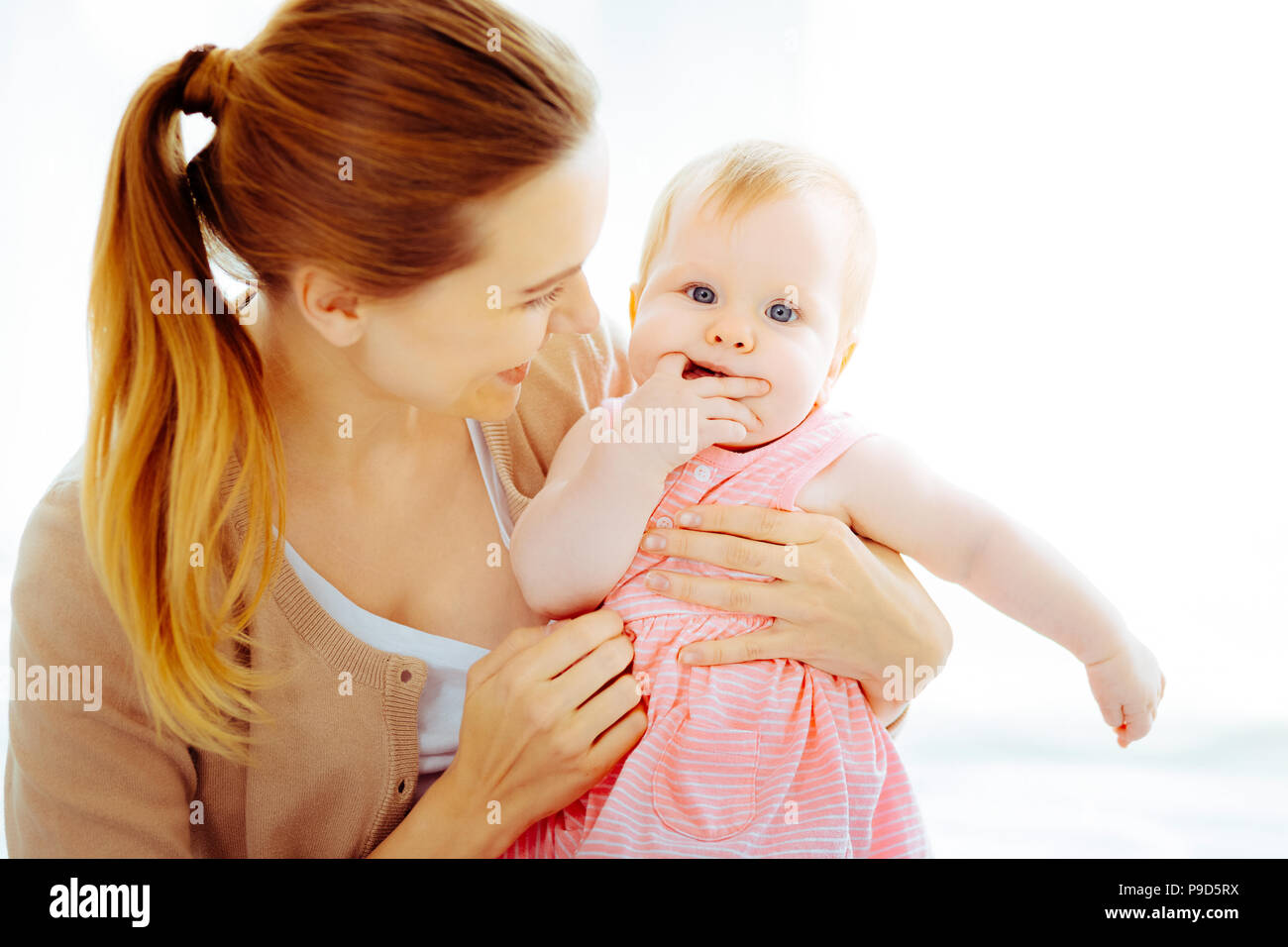 Happy female person playing with her baby Stock Photo - Alamy