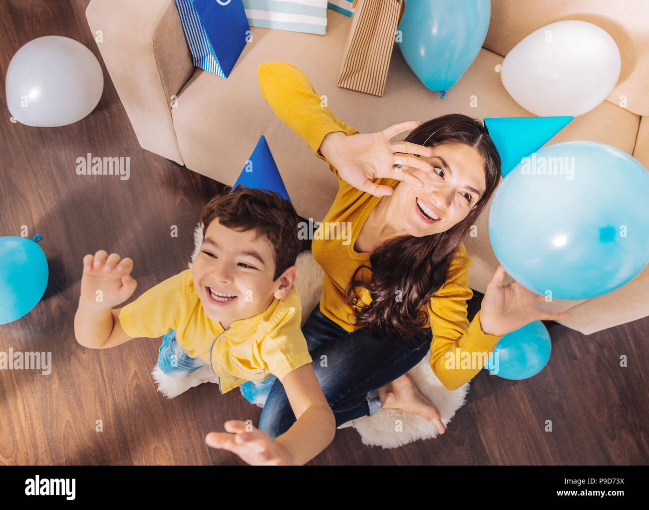 Joyful boy trying to catch balloon Stock Photo - Alamy