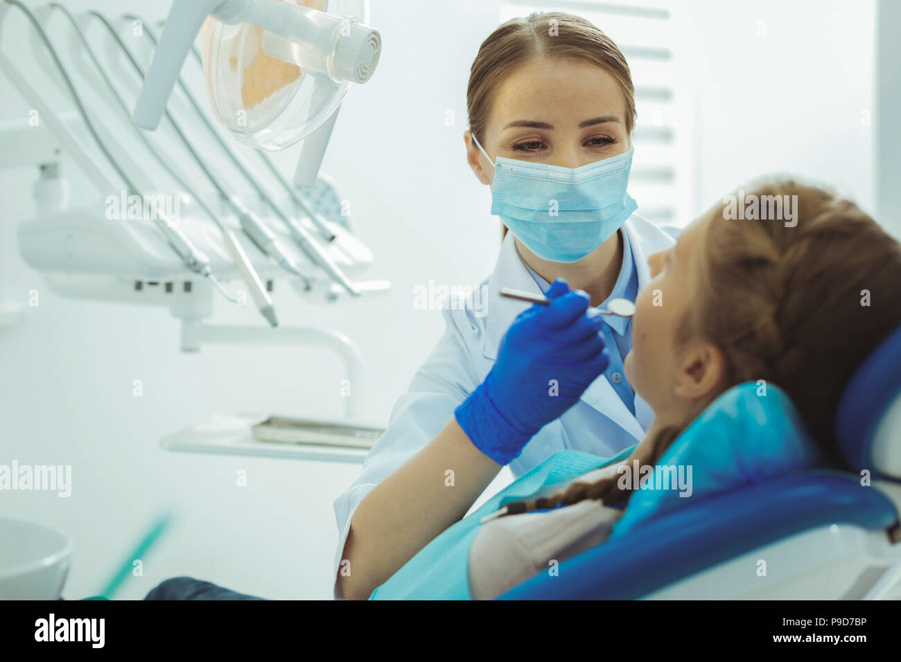Scared girl visiting her stomatologist Stock Photo - Alamy