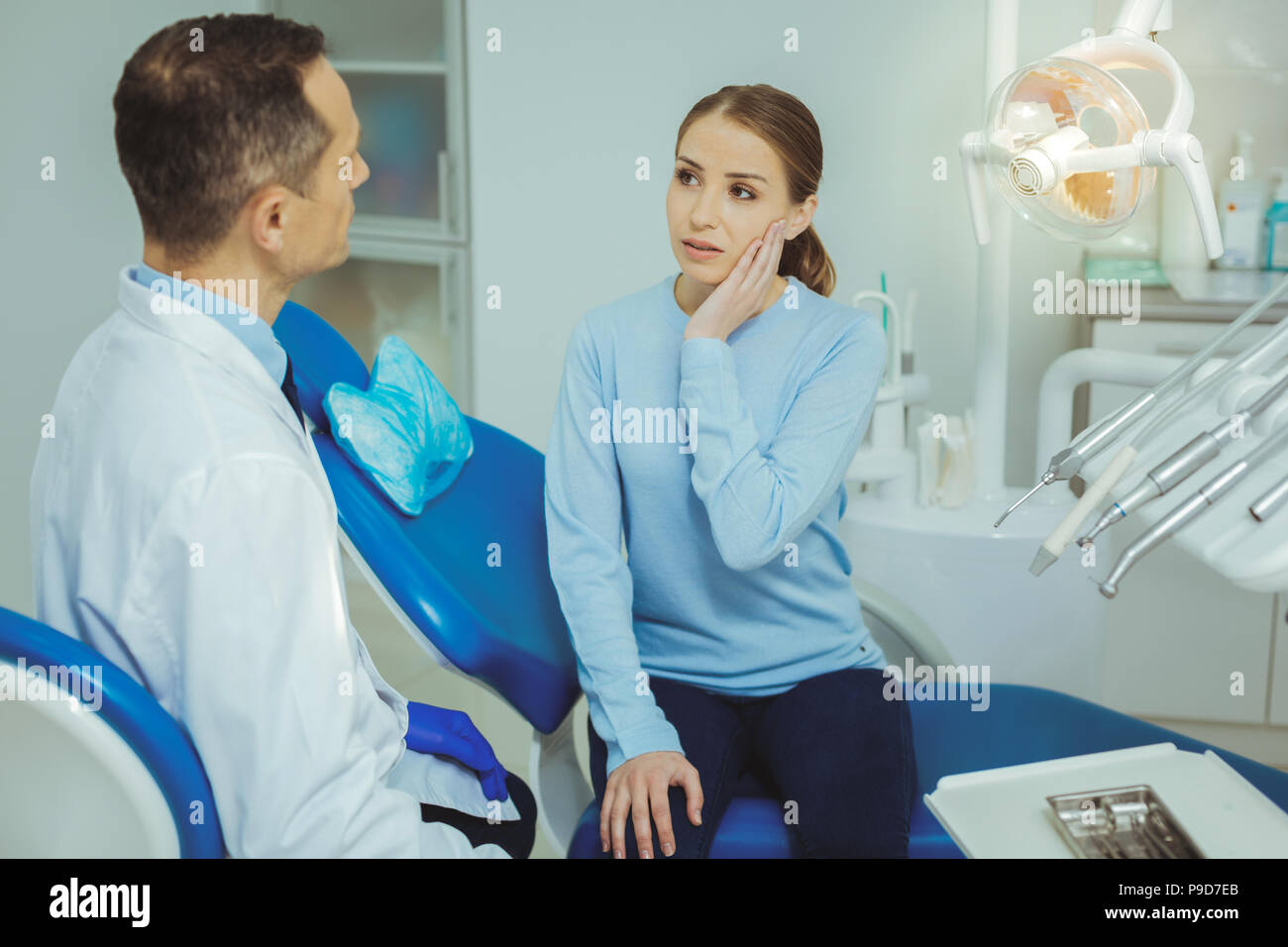 Young female person suffering pain Stock Photo - Alamy