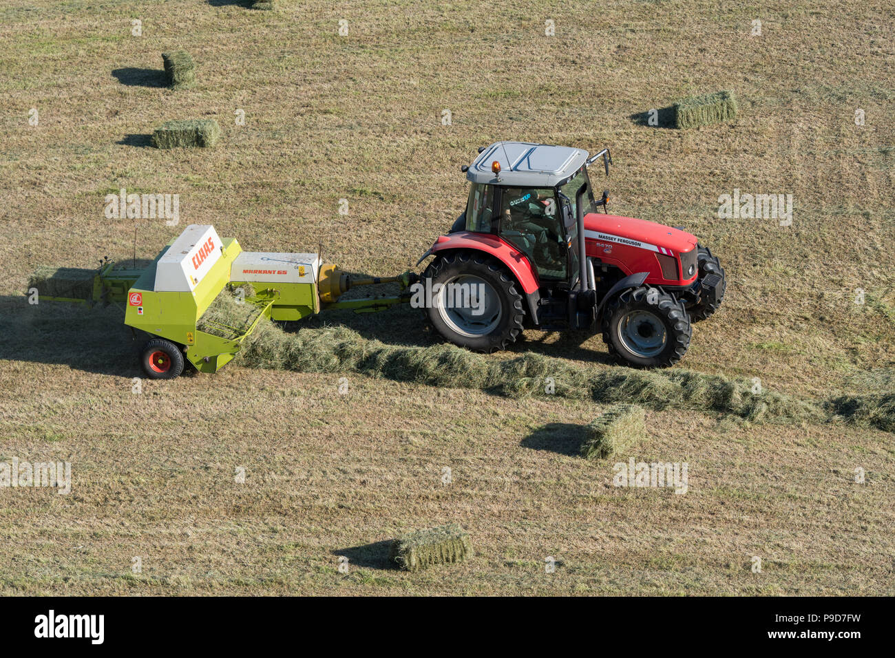 Farmer in Swaledale, North Yorkshire making bales of hay, using a ...