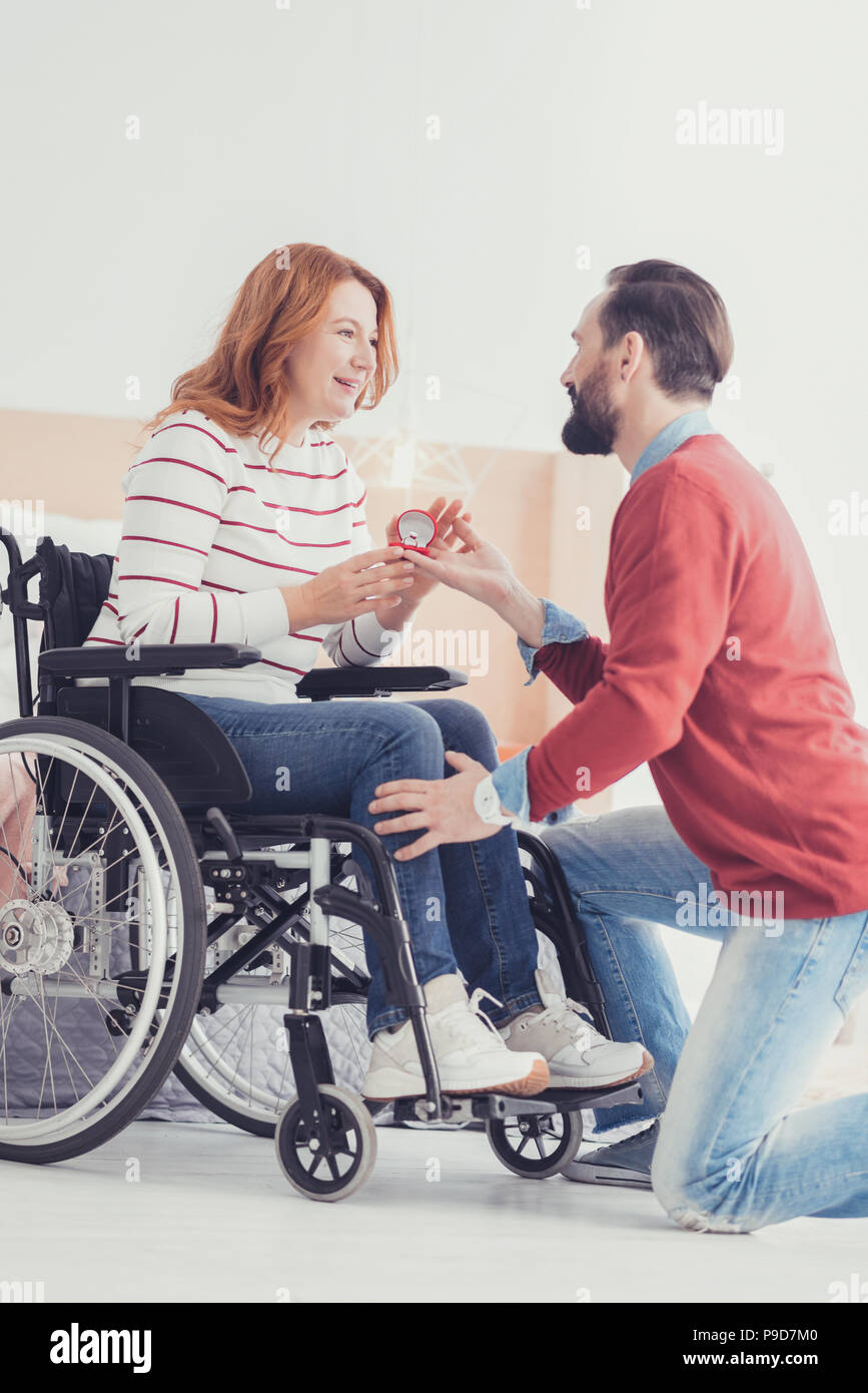 Romantic man asking his beloved woman to marry him and looking at her ...