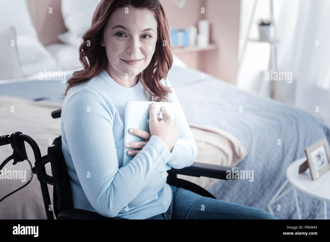 Portrait of kind woman that embracing her book Stock Photo - Alamy