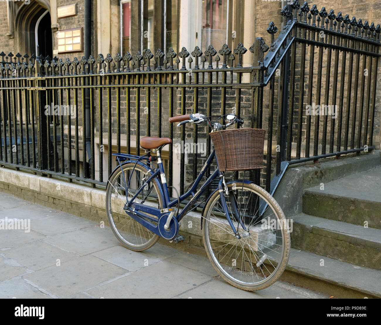 Bicycle chained to railings in Cambridge, UK Stock Photo - Alamy