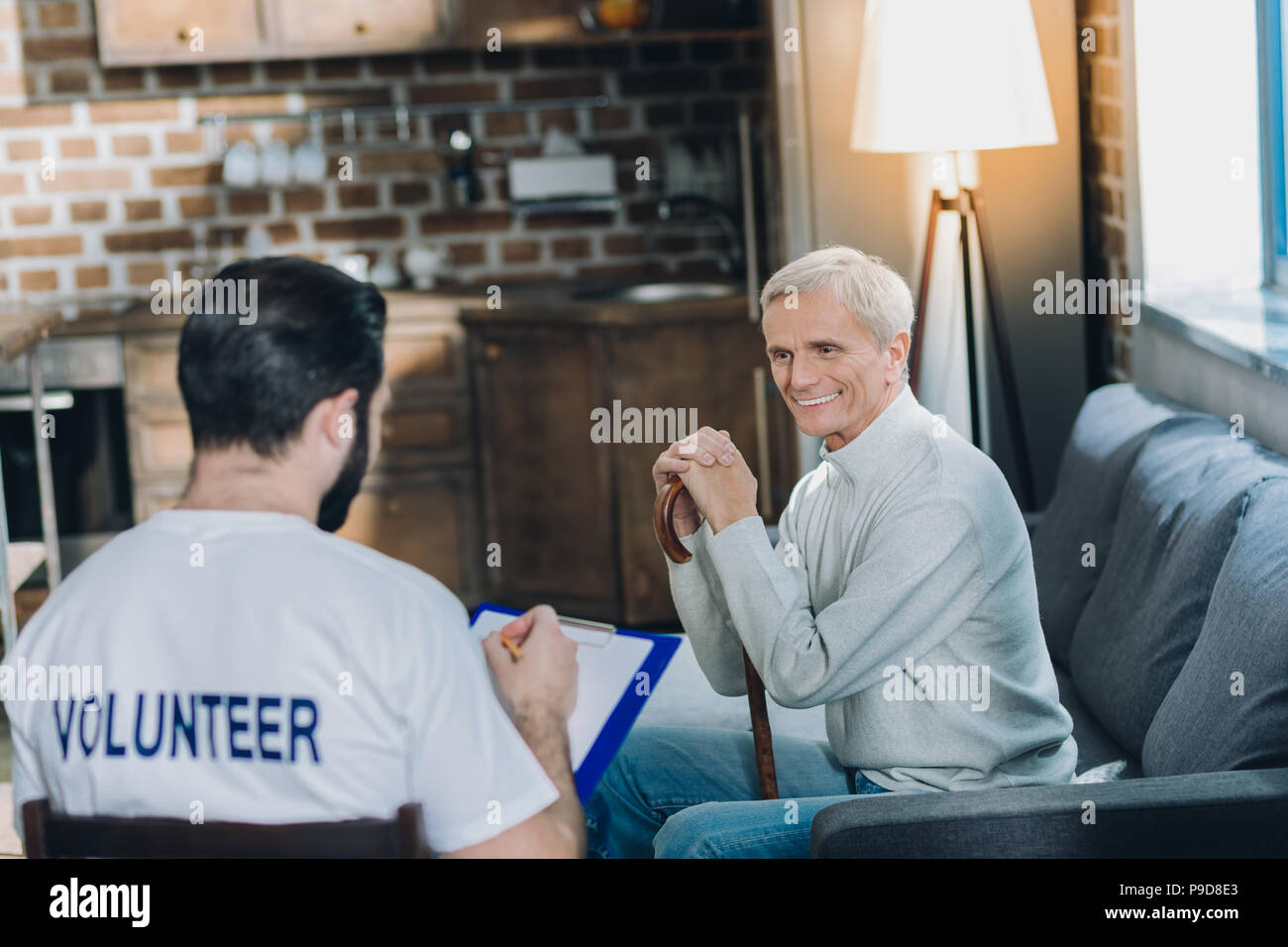 Happy old man answering questions Stock Photo - Alamy
