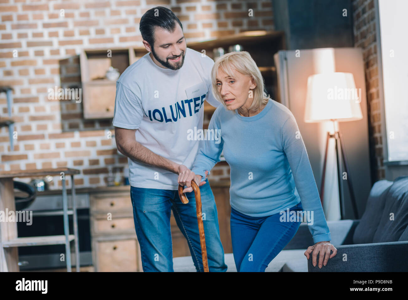 Kind man helping an old woman Stock Photo - Alamy