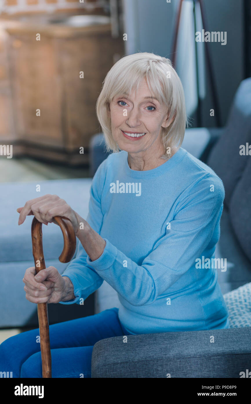 Alert woman holding a stick Stock Photo - Alamy