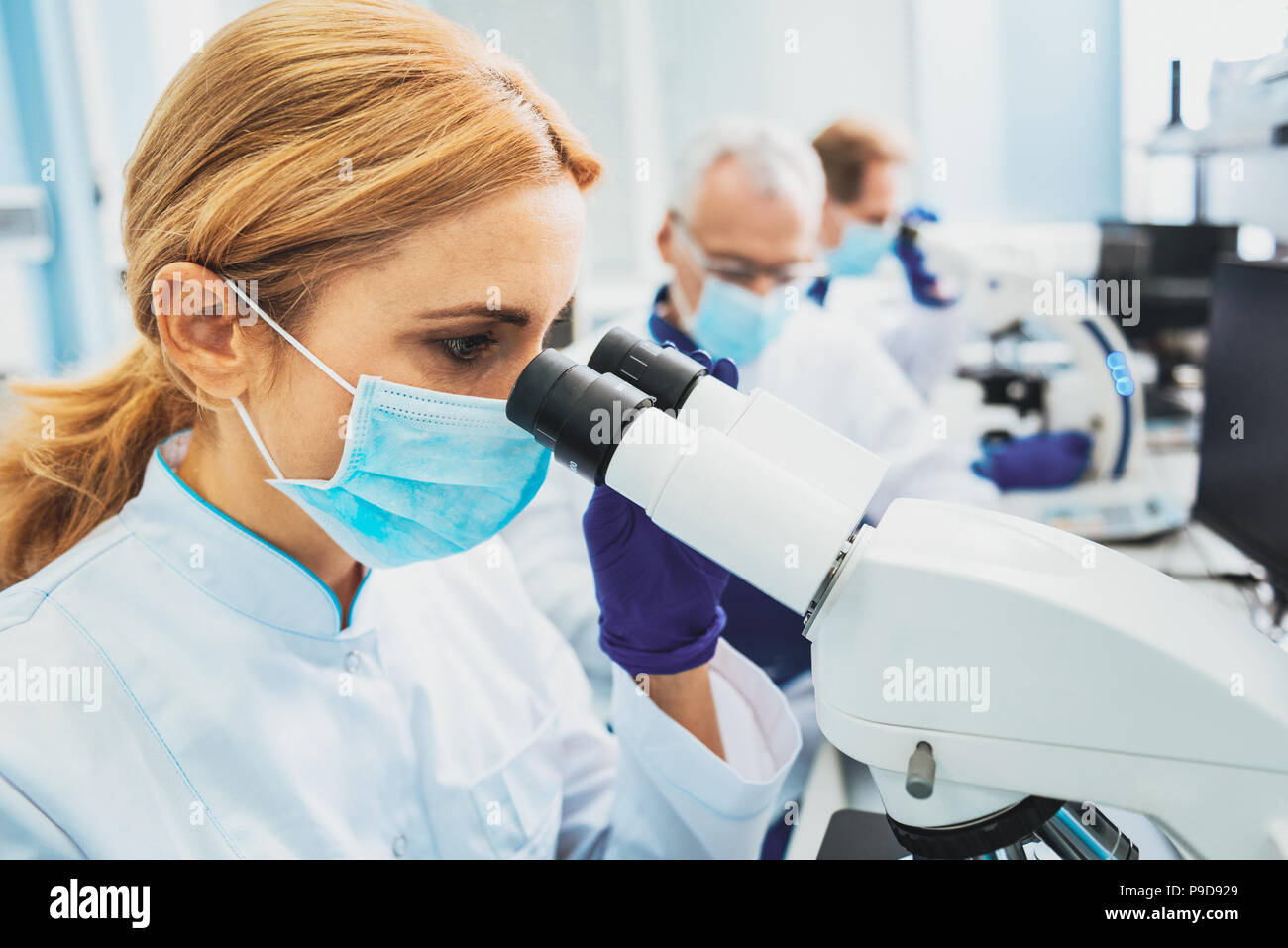 Close up of lab assistant that using microscope Stock Photo - Alamy