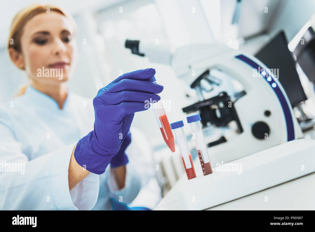 Serious female person working in laboratory Stock Photo - Alamy