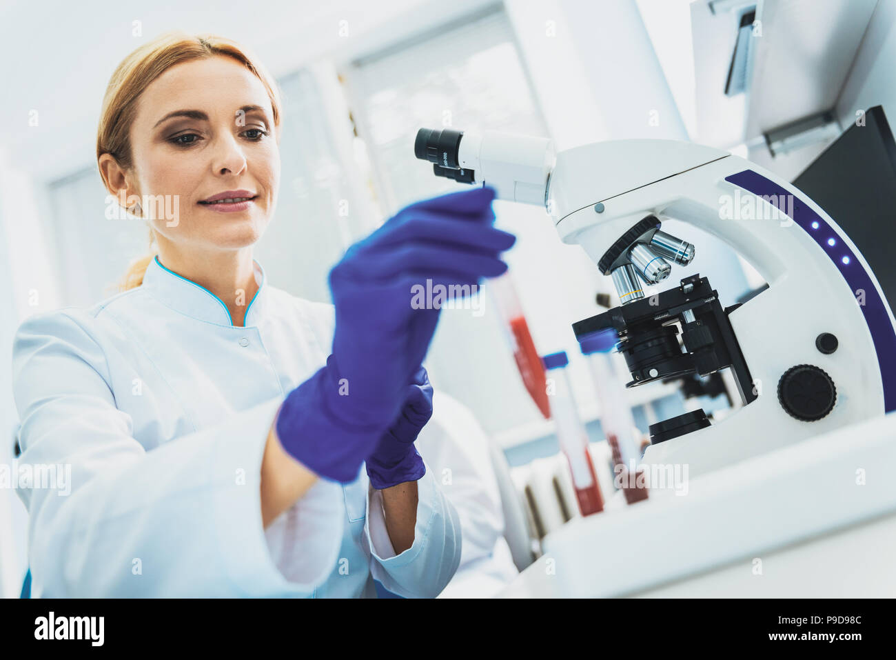 Concentrated woman taking biological product Stock Photo - Alamy