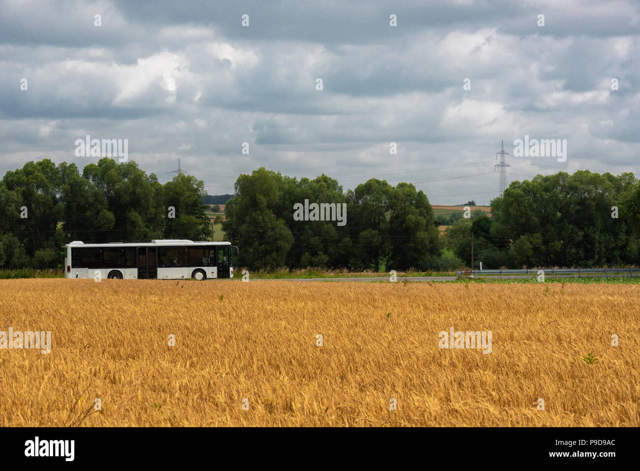 Public german transportation bus driving in a rural landscape ...