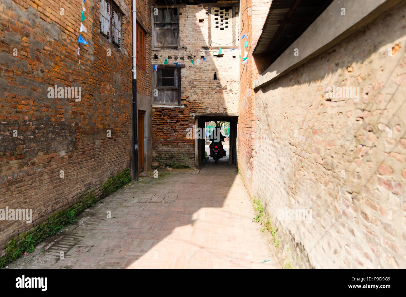 Motorbike riding in the narrow streets of Patan, Nepal Stock Photo - Alamy