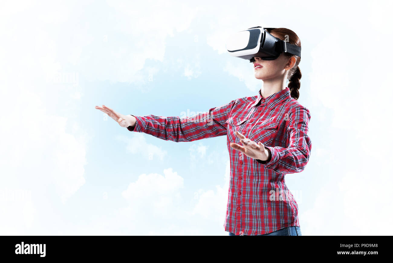 Girl in checked shirt wearing VR glasses experiencing another re Stock ...