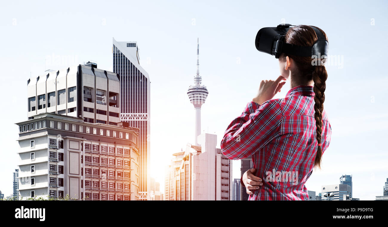 Girl in checked shirt wearing VR glasses experiencing another re Stock ...