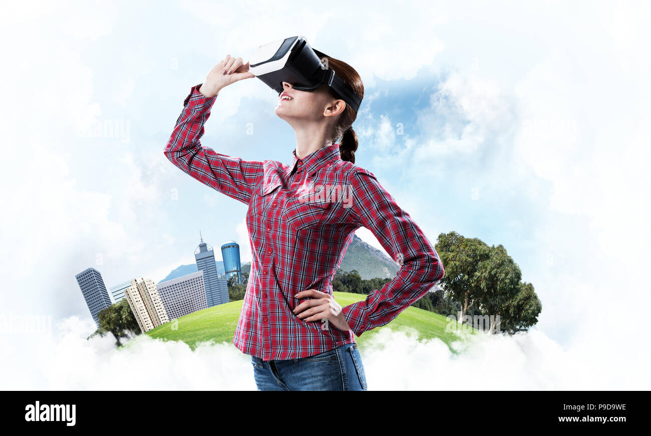 Girl in checked shirt wearing VR glasses experiencing another re Stock ...