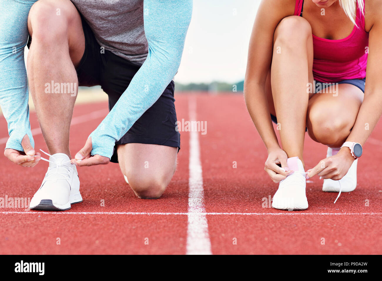 Picture showing man and woman racing on outdoor track Stock Photo - Alamy