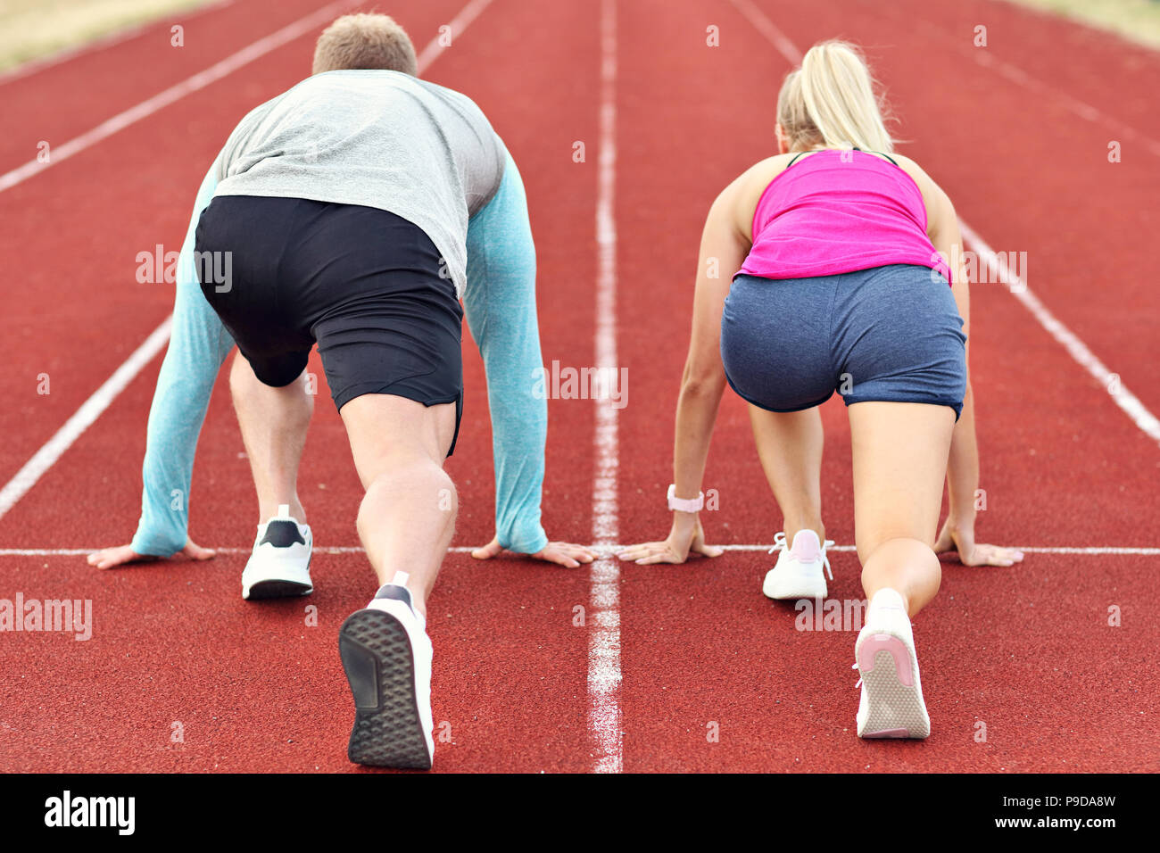 Picture showing man and woman racing on outdoor track Stock Photo - Alamy