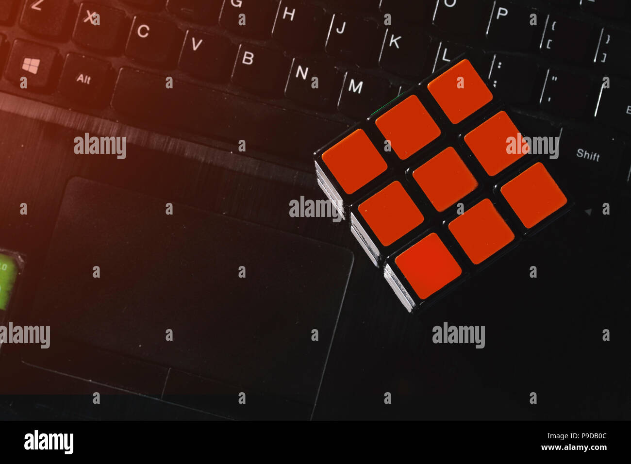 Problem solving cube near Laptop keyboard Stock Photo - Alamy