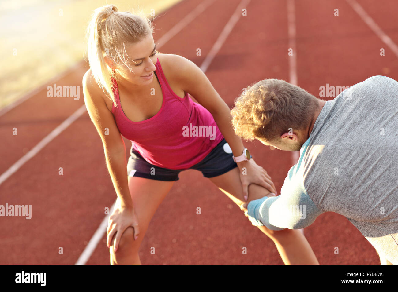 Man and woman racing on outdoor track Stock Photo - Alamy