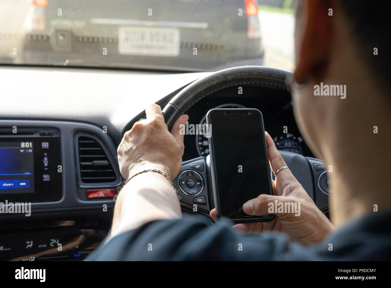 overhead shot a Man using mobile phone while driving a car, Modern ...