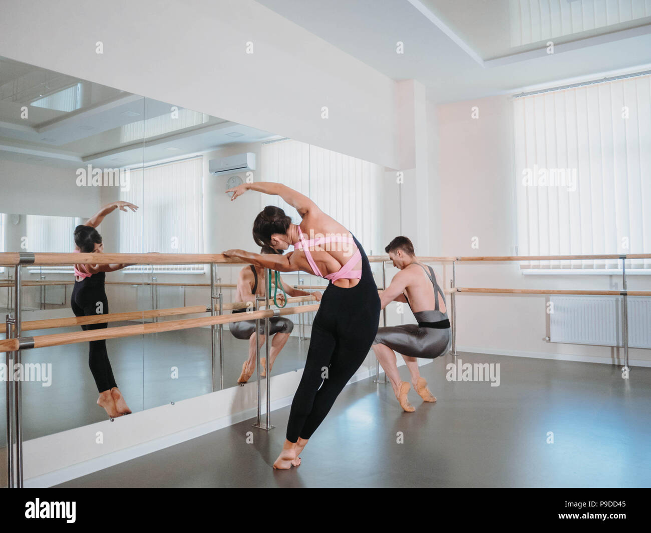 Preparation of body before performance in ballet studio. Male dancer ...