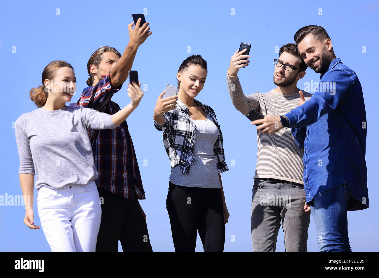Group friends posing smartphone camera hi-res stock photography and ...