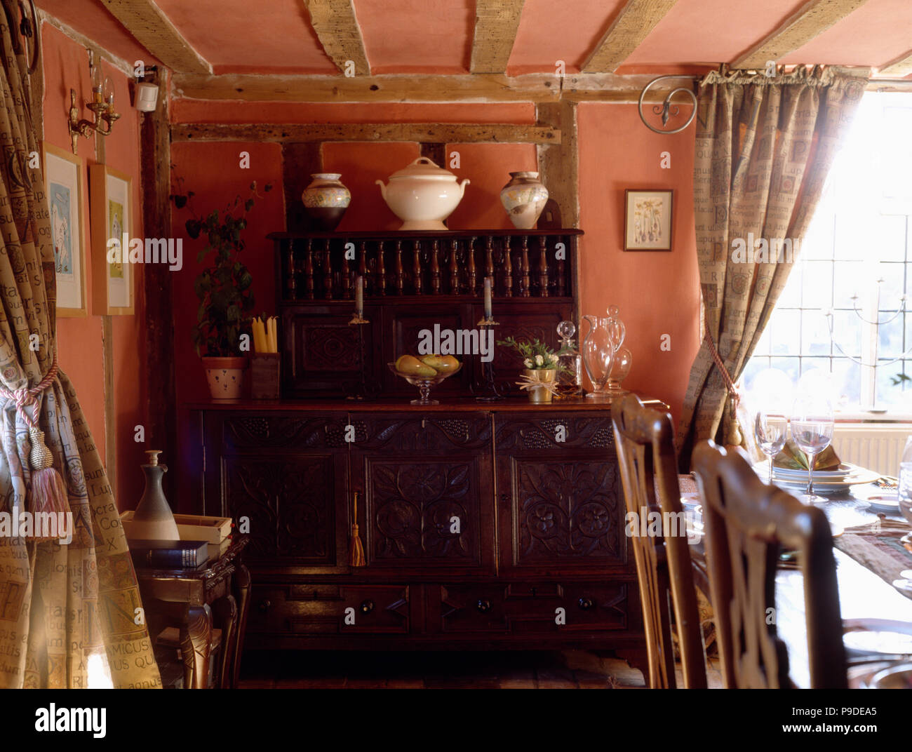 Carved wooden Jacobean-style dresser in terracotta painted country ...