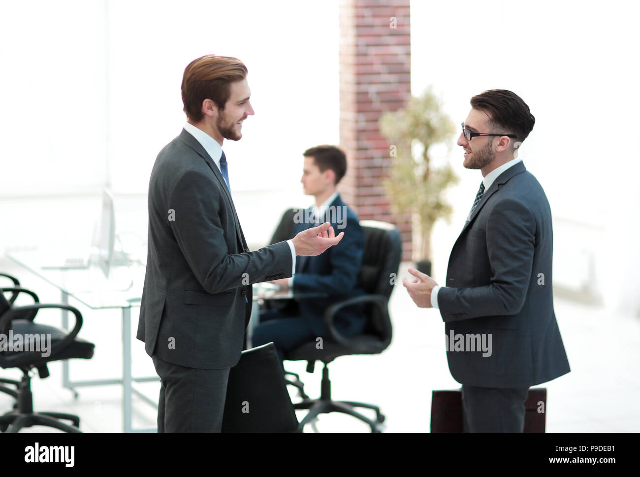 Two employees in business suits work in a conference hall Stock Photo ...