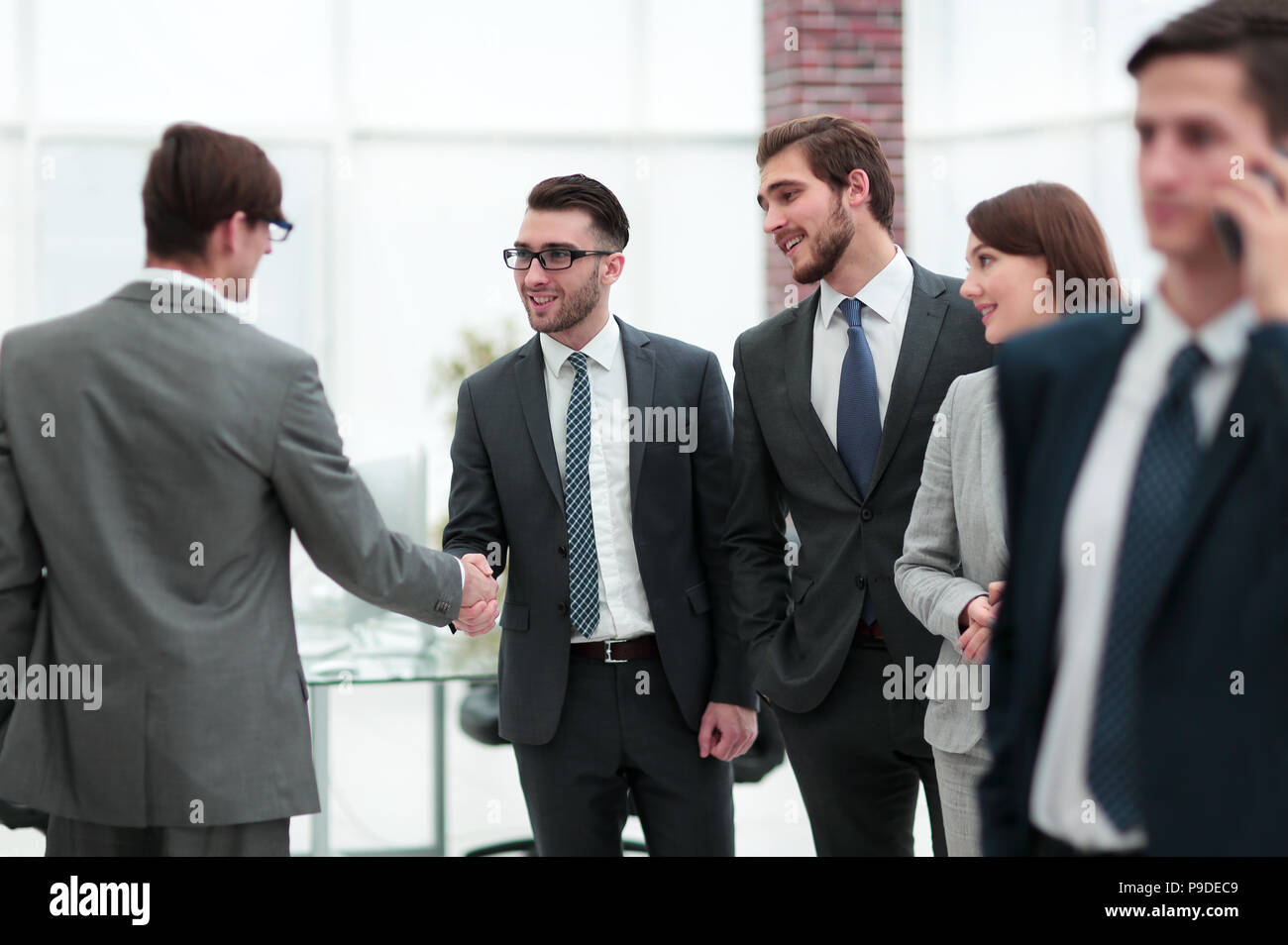 Confident young people, handshake and smile Stock Photo - Alamy
