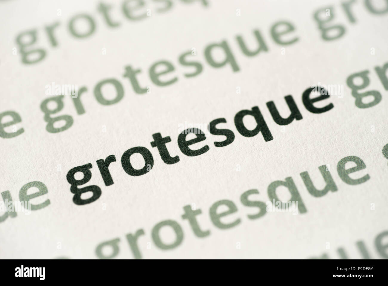 word grotesque printed on white paper macro Stock Photo - Alamy