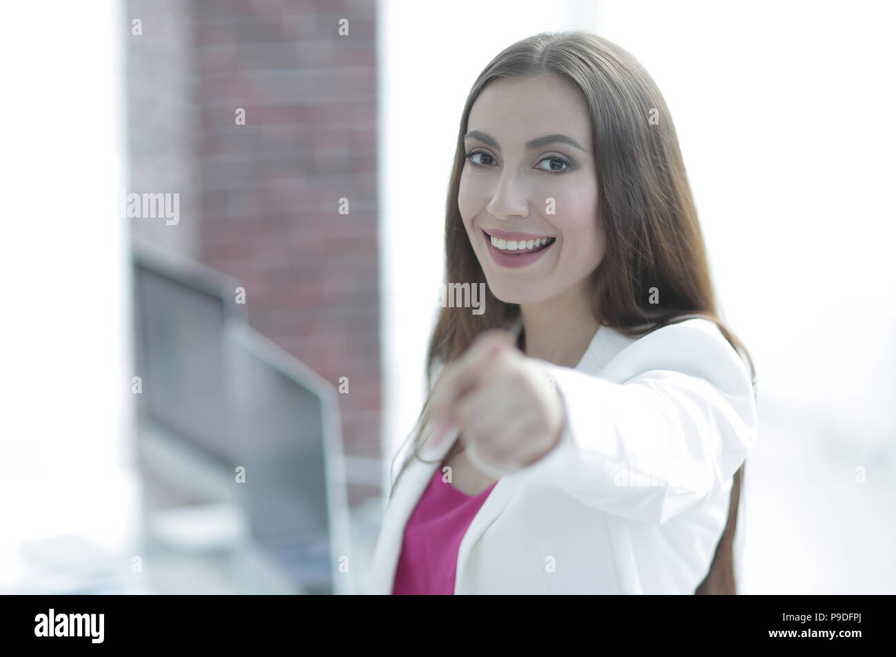 confident business woman pointing finger forward Stock Photo - Alamy