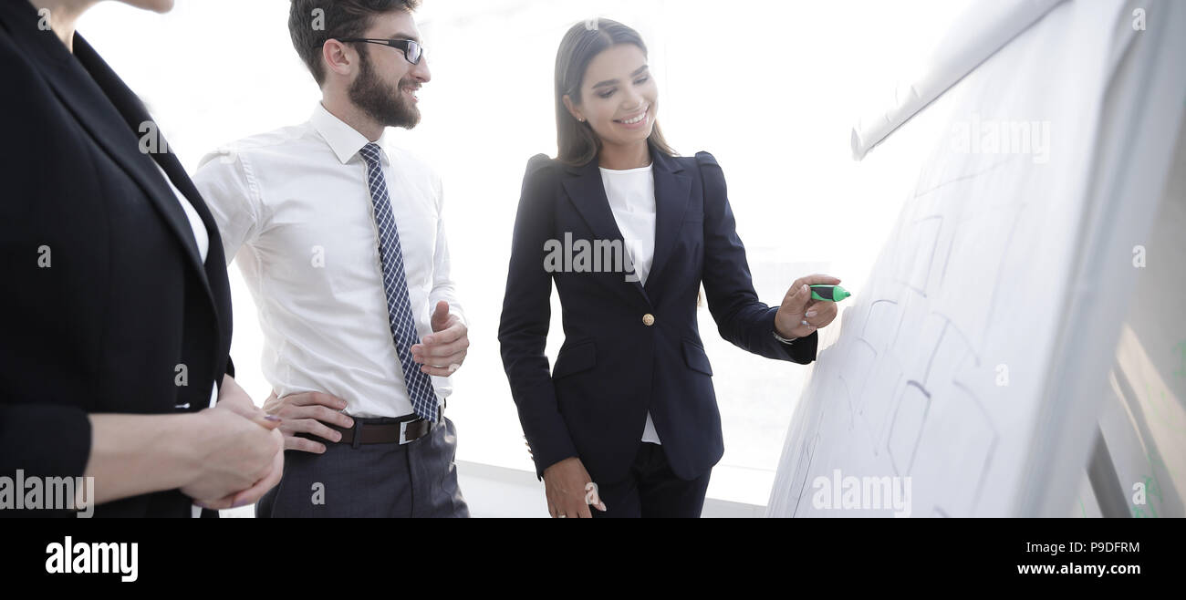 businesswoman pointing marker to flipboard on presentation in office ...