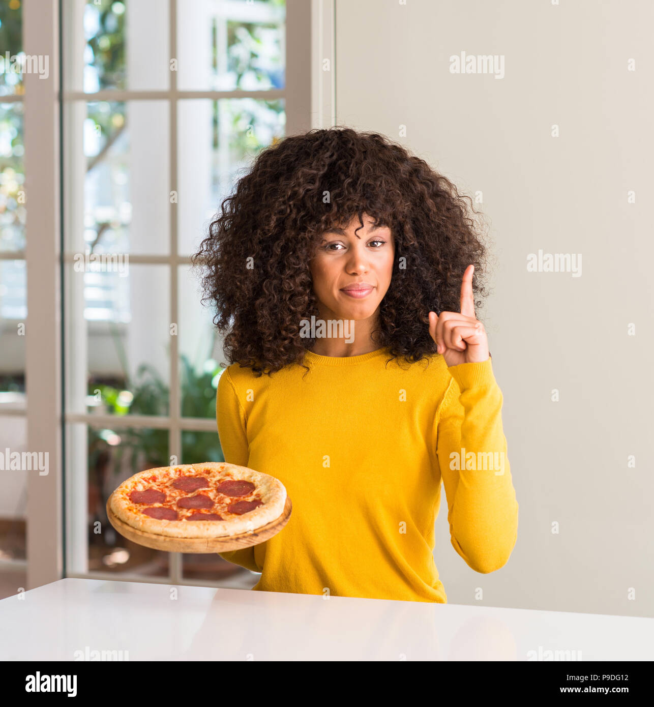 African american woman ready to eat tasty pepperoni pizza at home ...