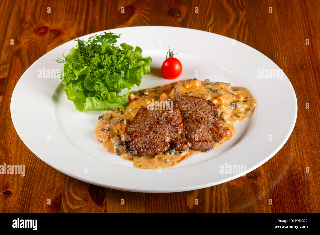 Beef with mushroom sauce served fresh herbs Stock Photo - Alamy