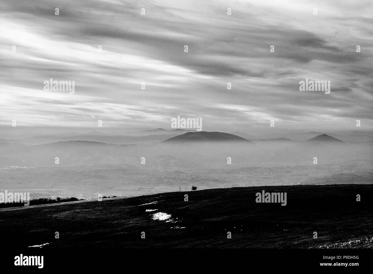 Subasio Mt. (Umbria, Italy), with sky covered by clouds and mist on the ...