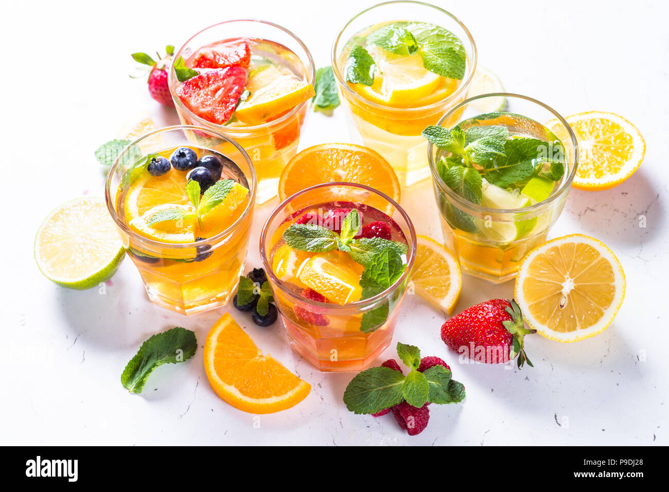 Summer drink assortment. Lemonade, mojito and strawberry lemonade in ...